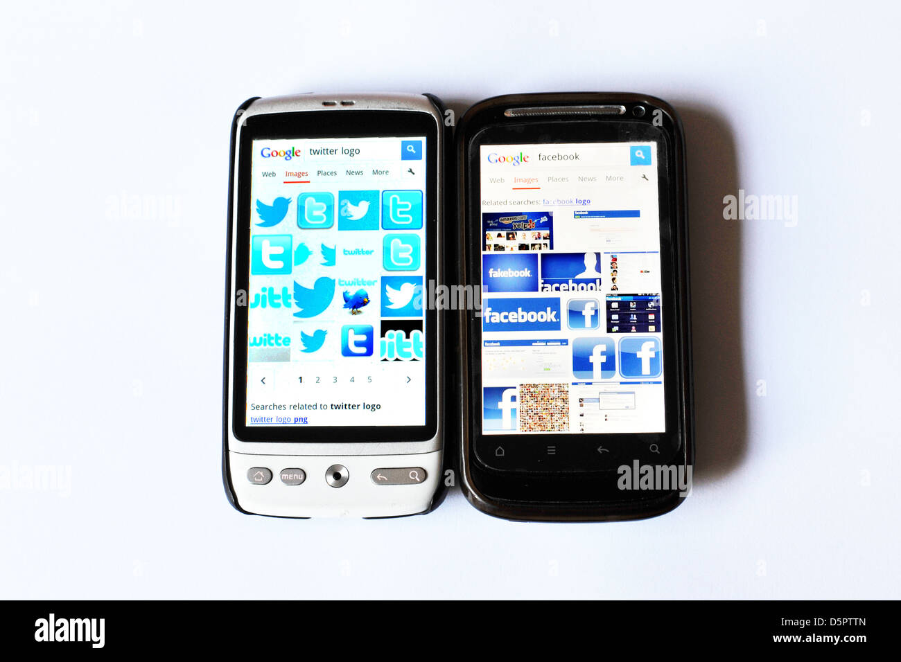 Two mobile phone screens showing web pages photographed in a studio ...