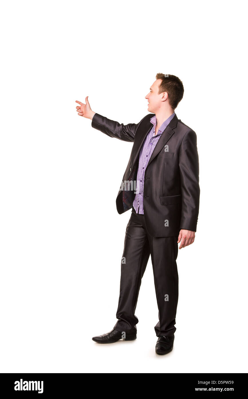 Happy young friendly smiling businessman pointing finger isolated on ...