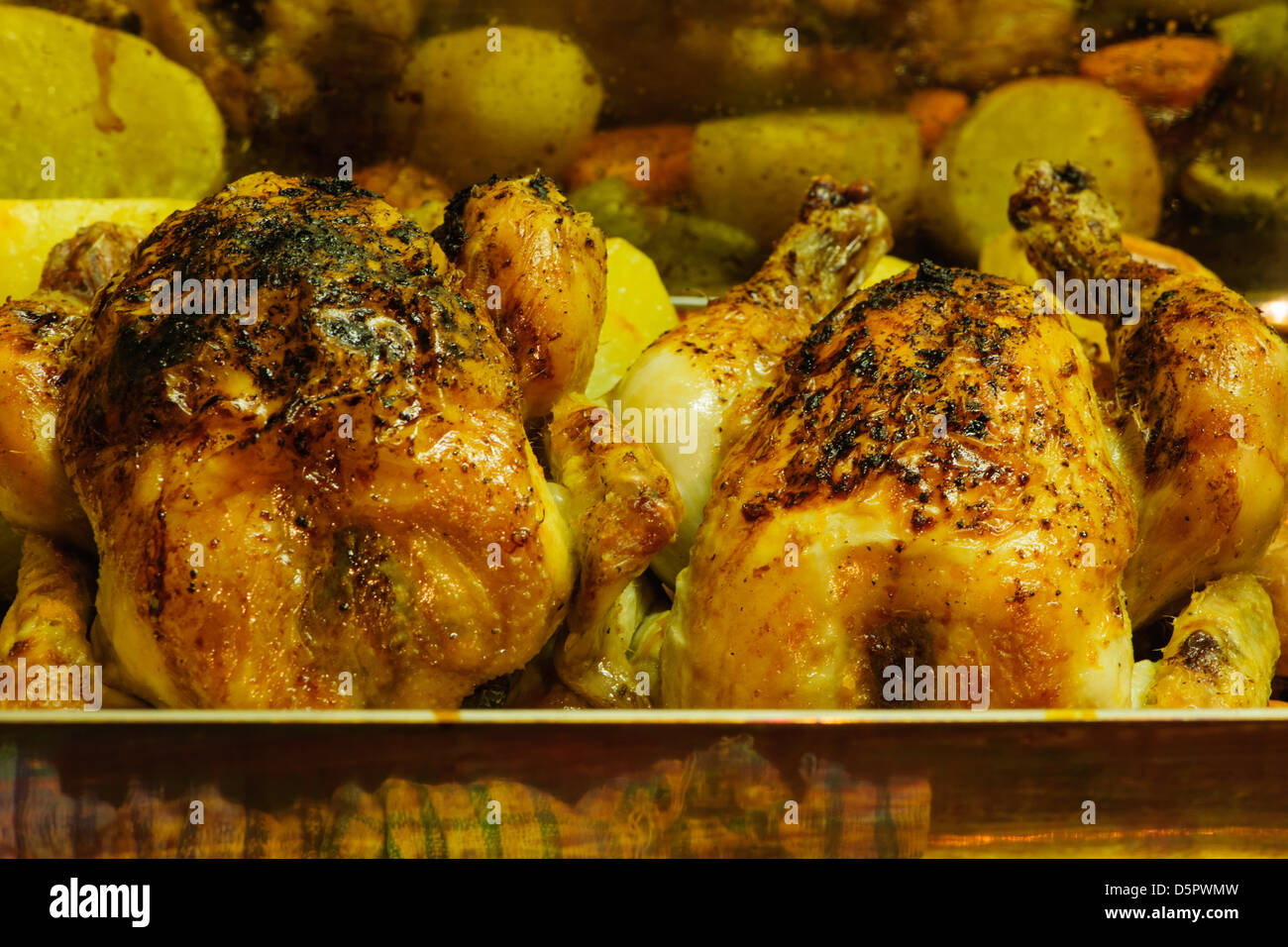 Roast poussin in a copper roasting dish ready to serve Stock Photo - Alamy