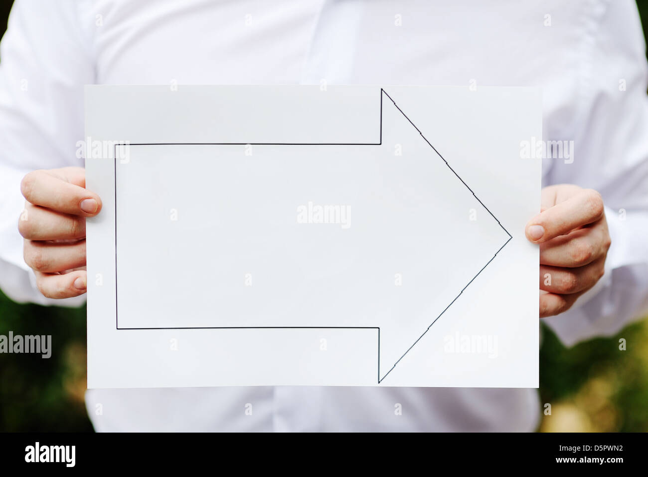 hands holding a sign with an arrow indicating right direction Stock ...