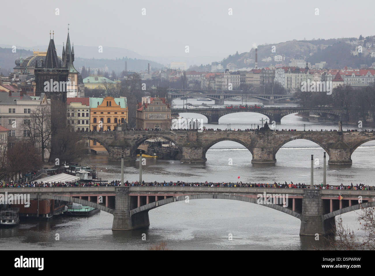 Athletes run over the Manes Bridge (Mánesův Bridge) over the Vltava ...