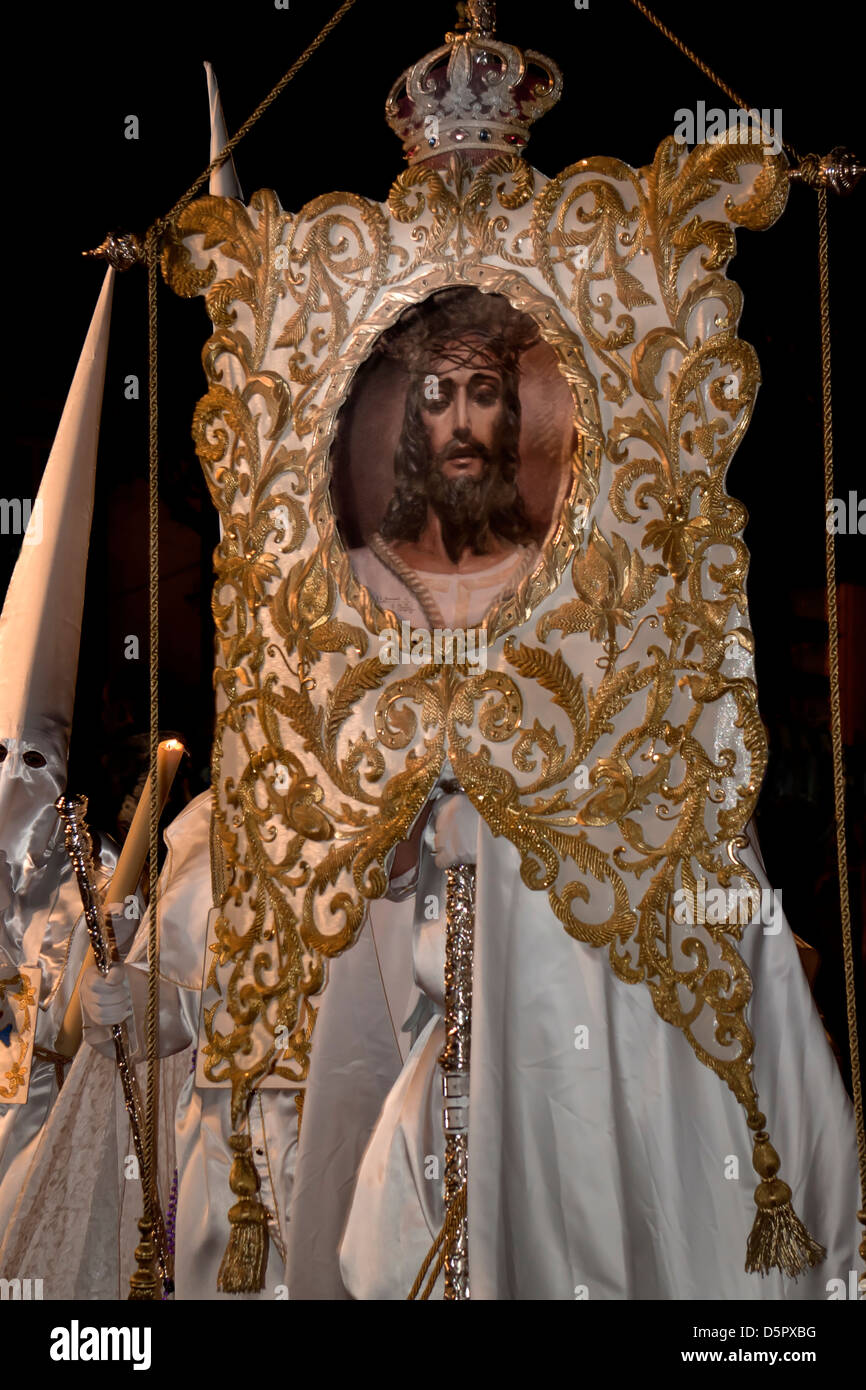 Nazarene dressed in white tunics, hoods and masks during the Semana ...