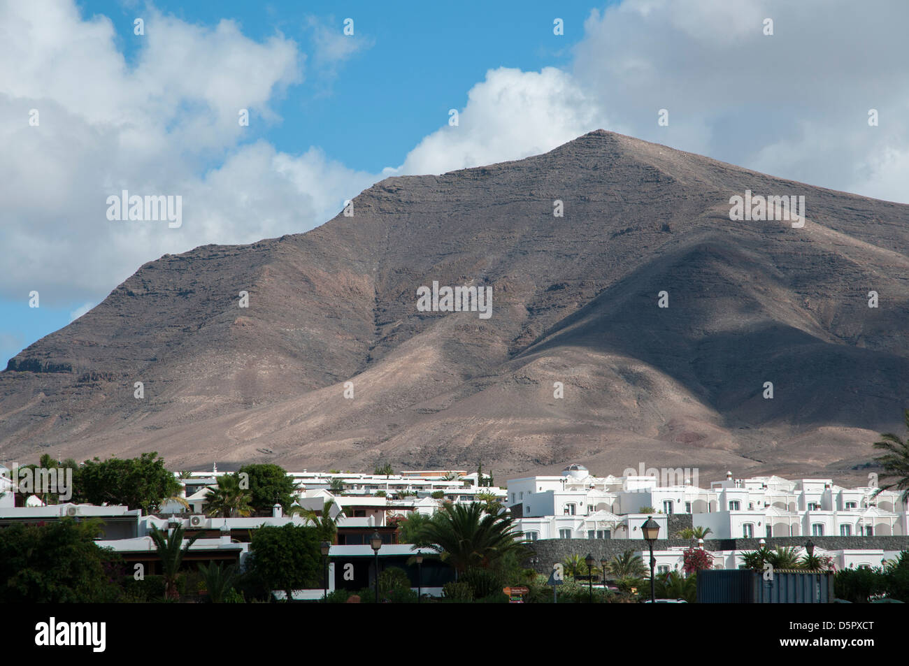 huge volcano above the white colored buildings Stock Photo - Alamy