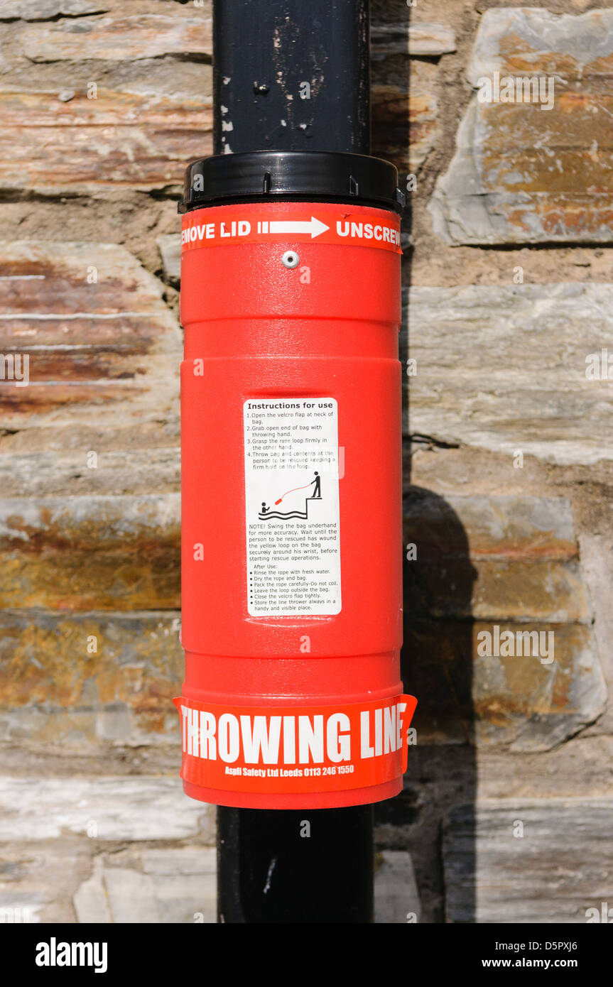Emergency throwing line on a harbour wall Stock Photo - Alamy