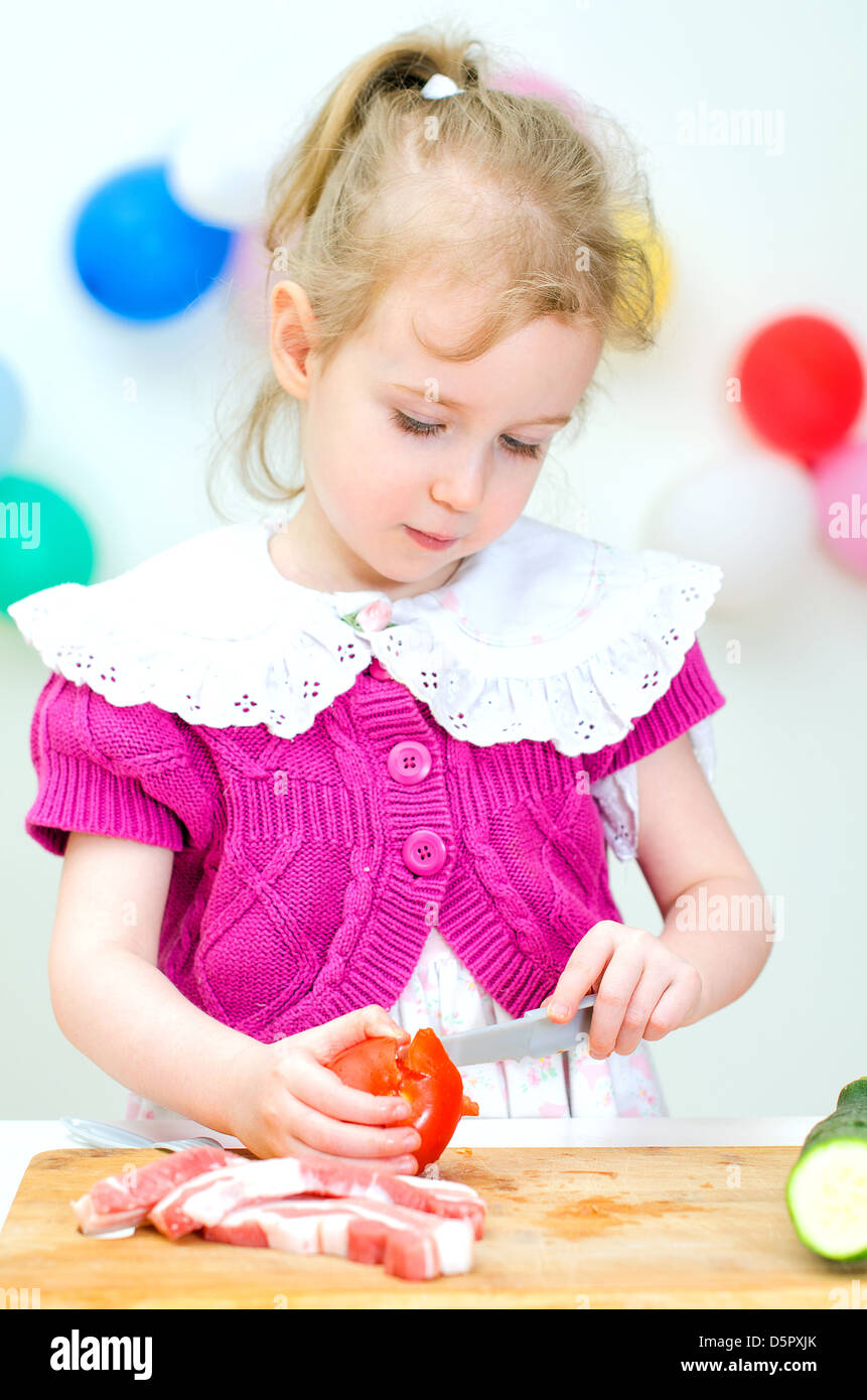 Little girl cooking dinner Stock Photo - Alamy
