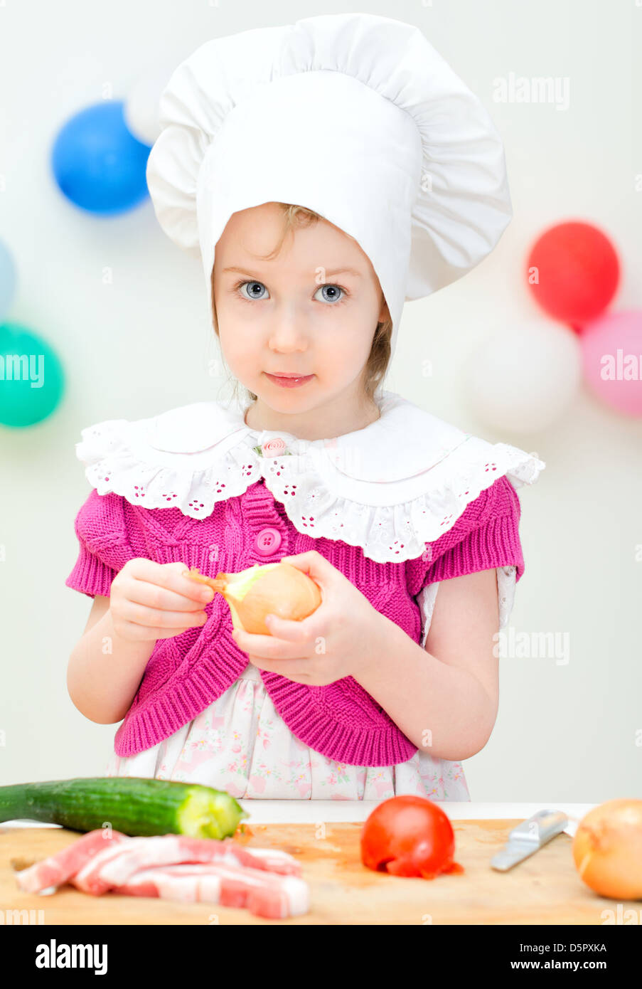 Little girl in chief hat cooking dinner Stock Photo - Alamy