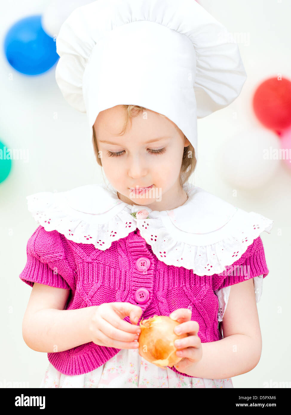 Little girl in chief hat cooking dinner Stock Photo - Alamy
