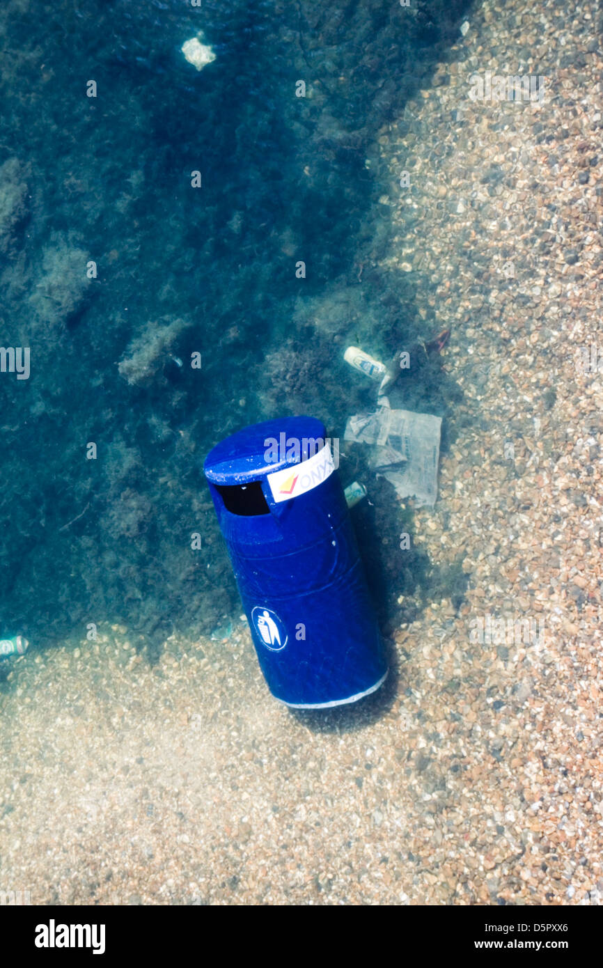 large litter bin dumped into a seawater pool by vandals Stock Photo - Alamy