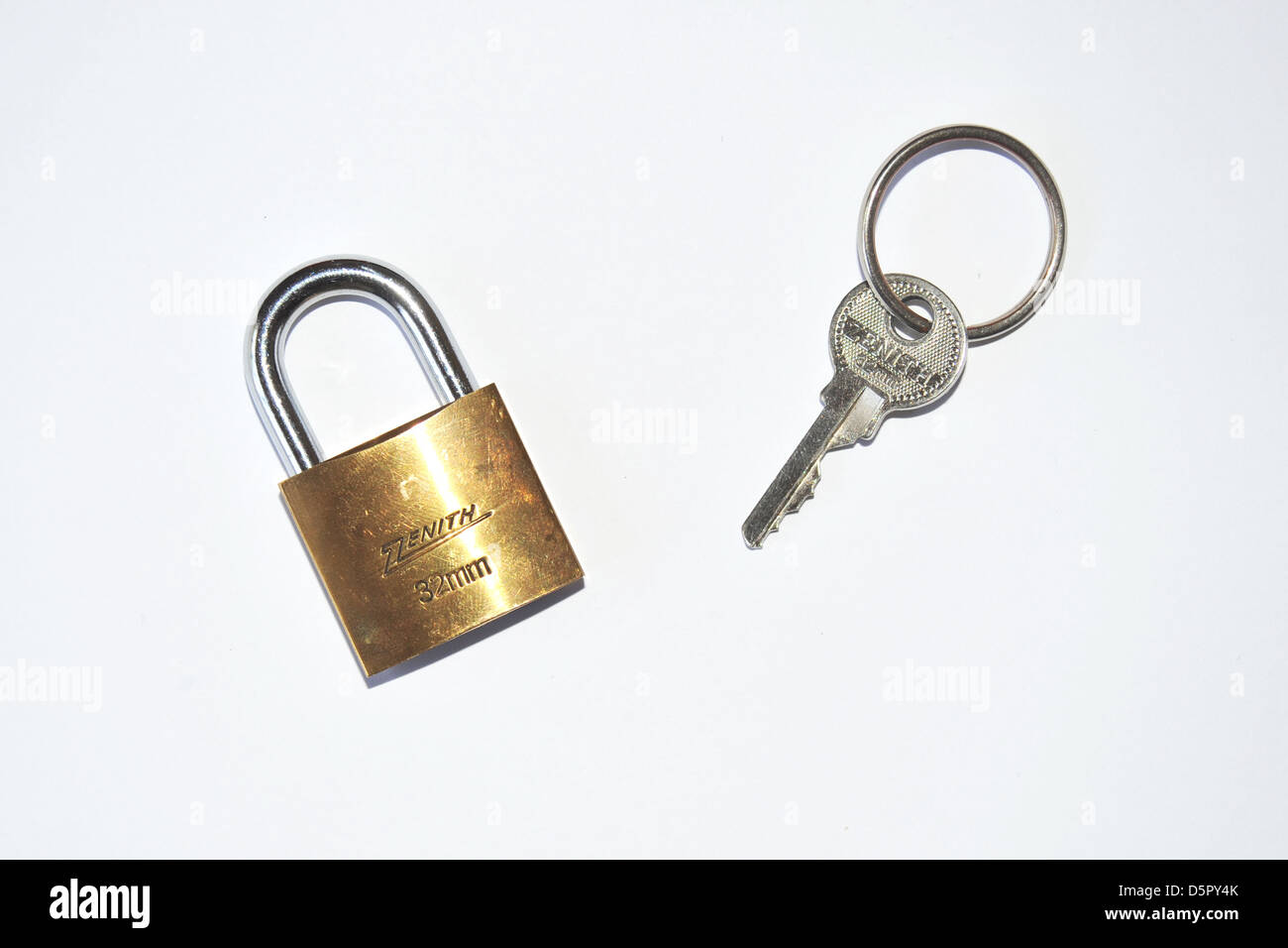 A locked Zenith padlock and key photographed in a studio Stock Photo ...