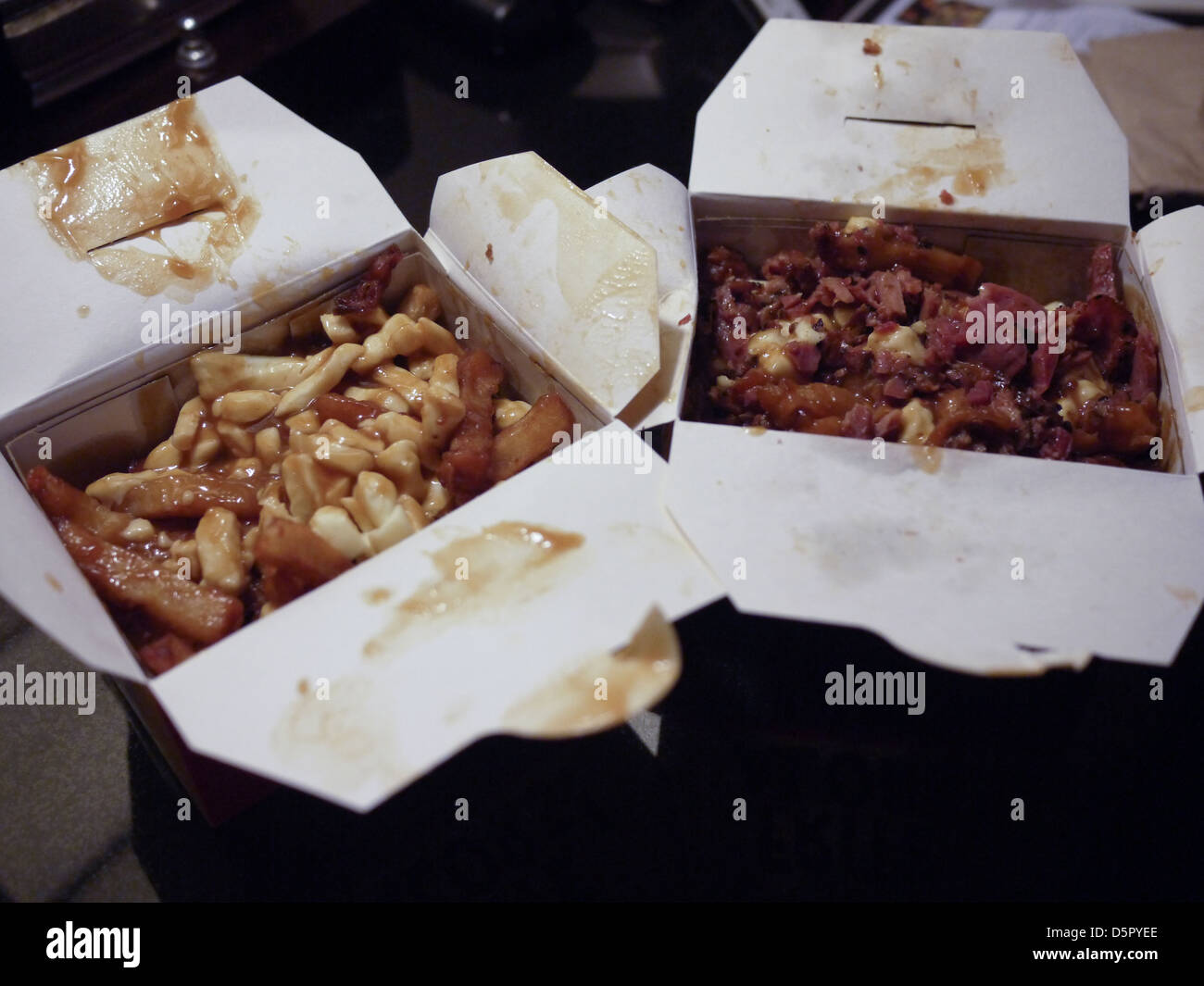 Poutine is a common Canadian dish, made with french fries, topped with ...