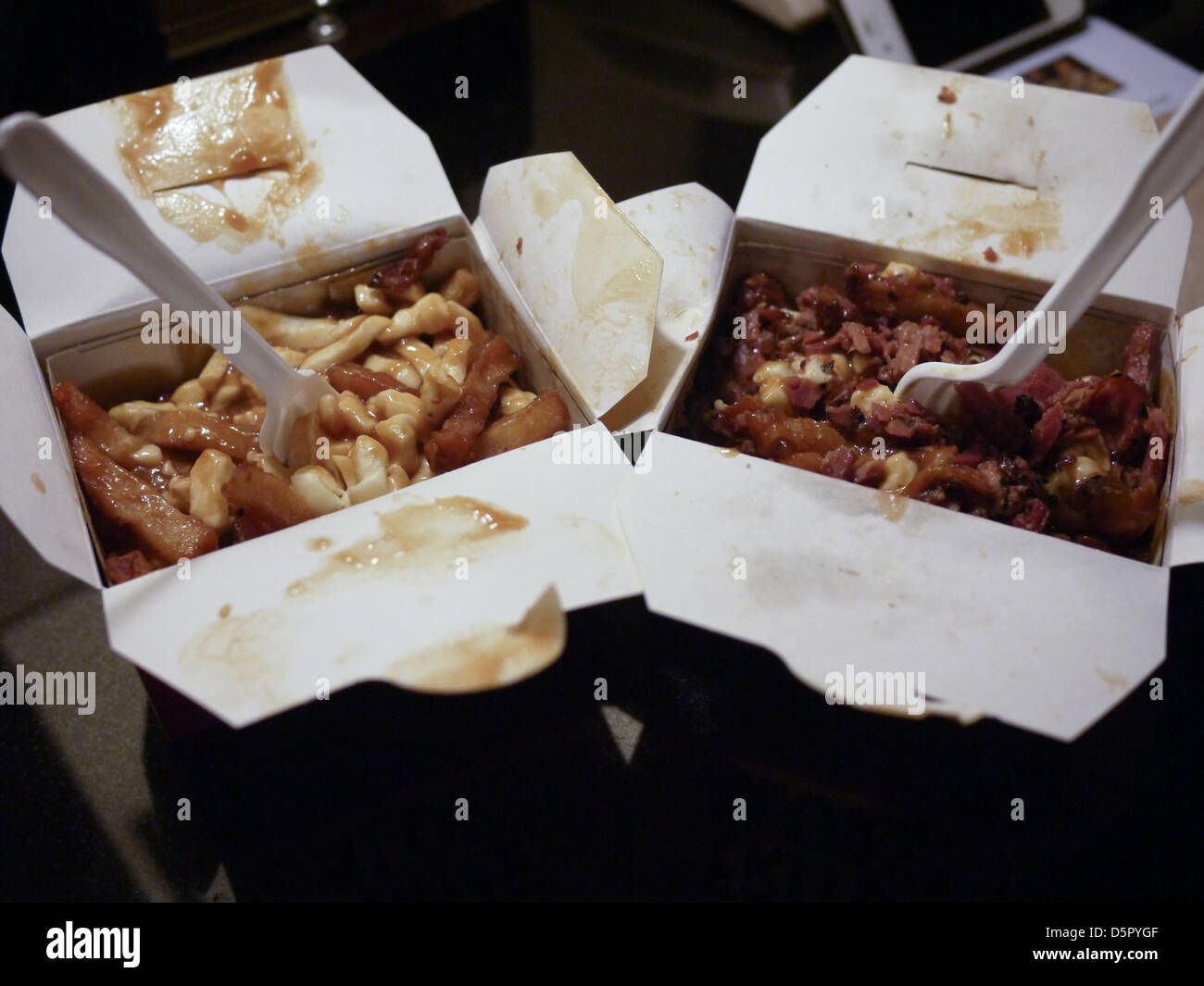 Poutine is a common Canadian dish, with French fries, topped with a ...