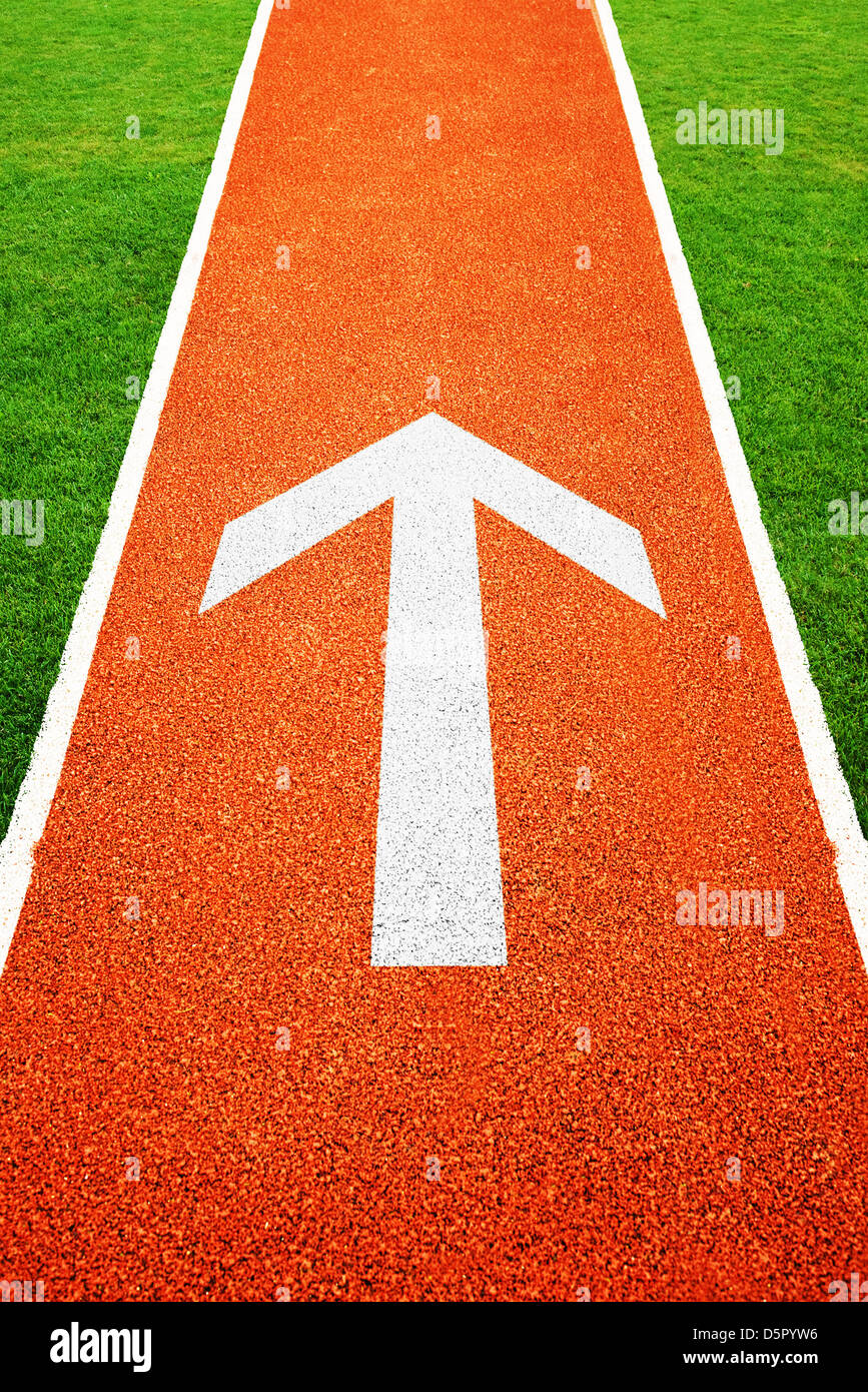 Arrow on athletics all weather running track Stock Photo - Alamy