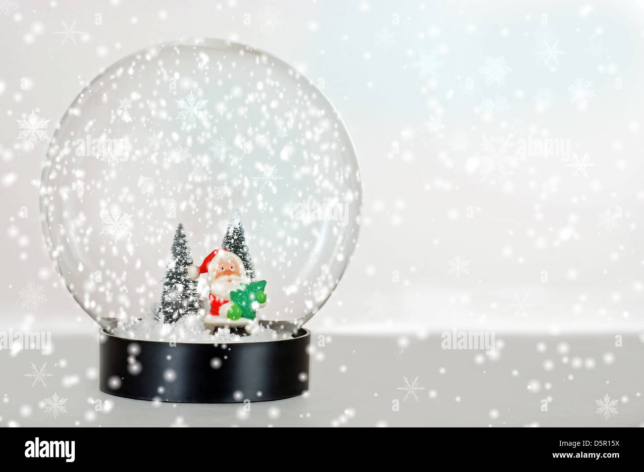 Santa snow globe with falling snow Stock Photo - Alamy