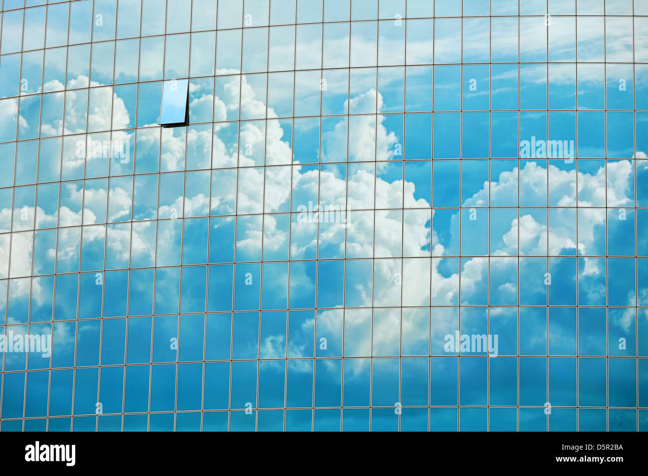 Cloudy sky reflected in the windows of a skyscraper - urban background ...