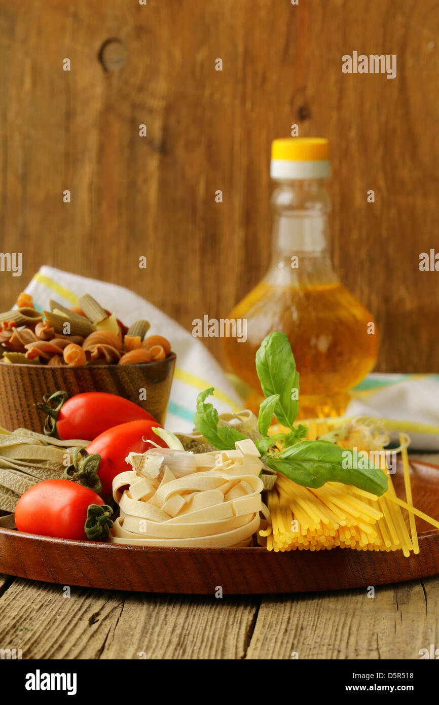 Various types of pasta (spaghetti, fettuccini, penne) and tomato Stock ...