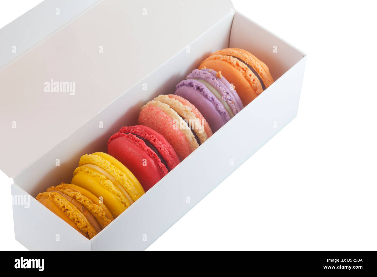 Half dozen colorful macarons in a gift box, cutout on white background ...