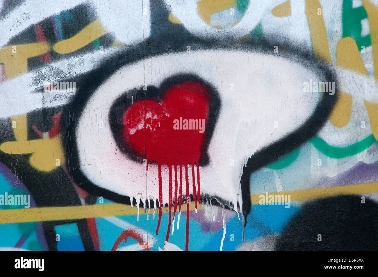 red bleeding heart graffiti on building wall Stock Photo - Alamy