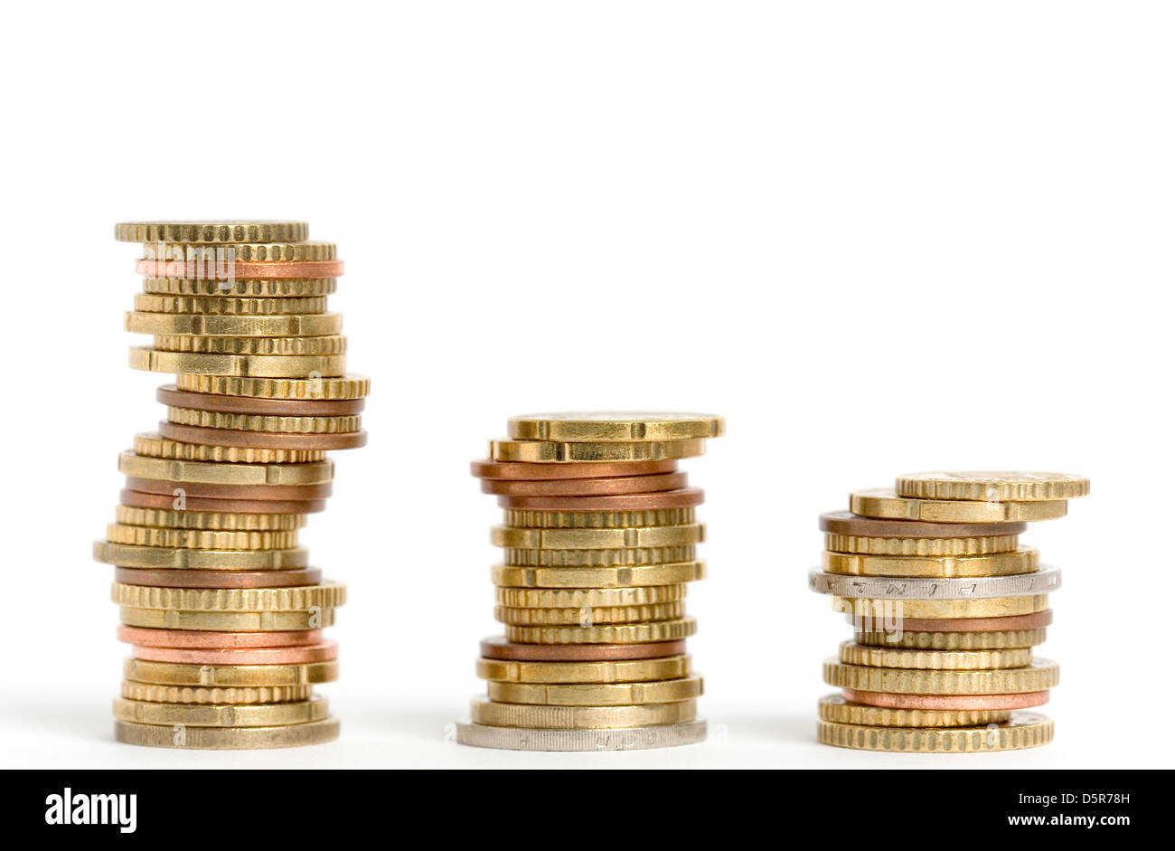 Three stacks of euro coins on white background Stock Photo - Alamy