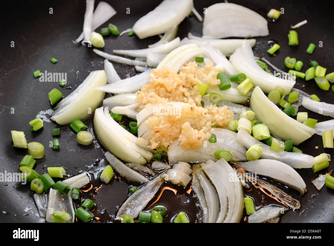 Onions with Garlic and Scallion Frying in a Pan Stock Photo - Alamy