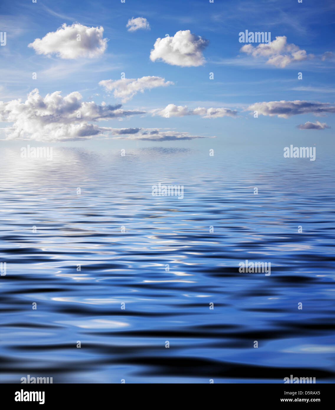 Blue sky with fluffy clouds and water reflection Stock Photo - Alamy