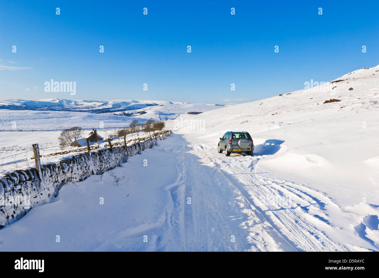 4x4 on Snow covered road near Hathersage Peak District National Park ...