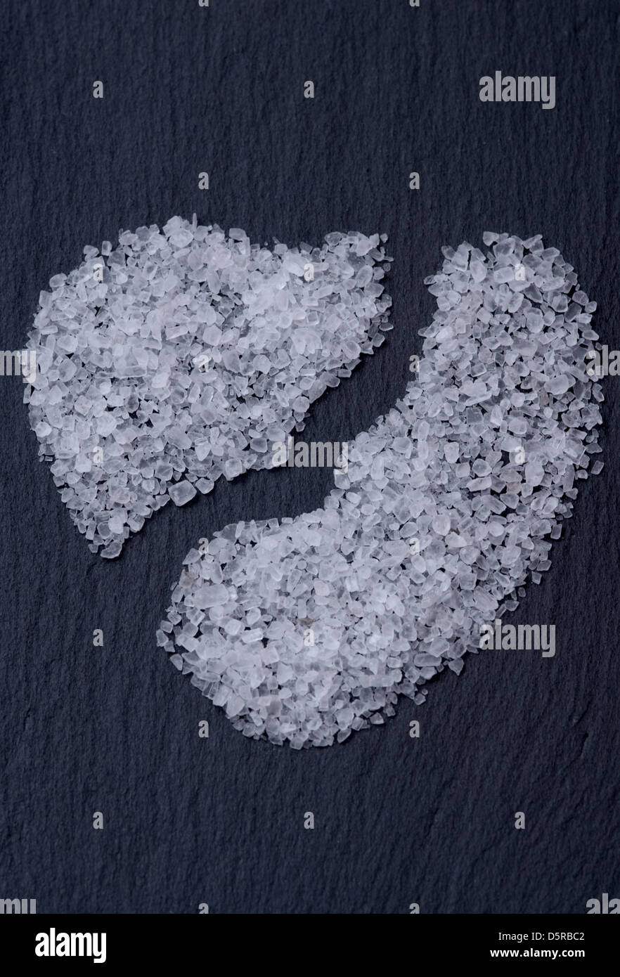 Still life image of Sea salt in a heart shape Stock Photo - Alamy