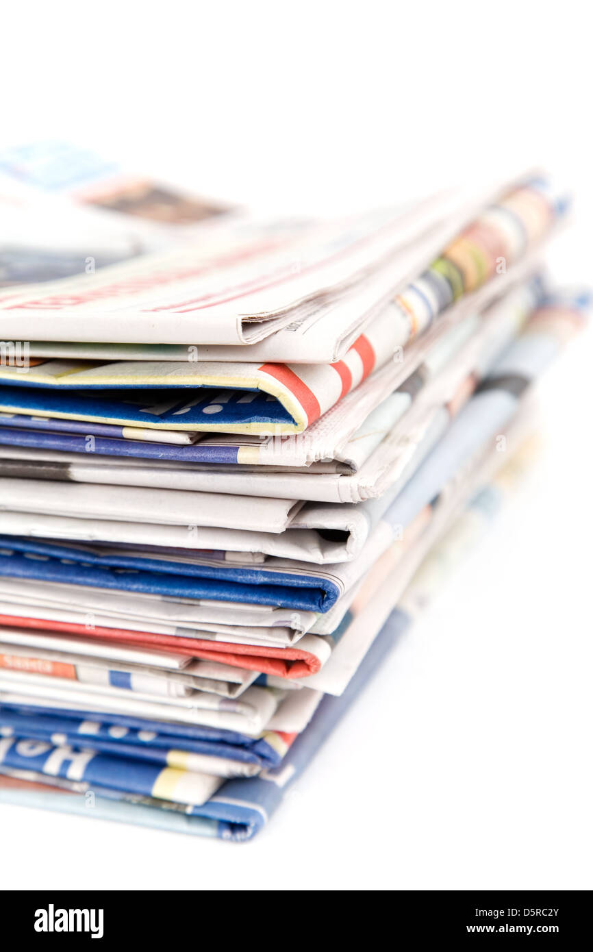 Stack of newspapers on white background Stock Photo - Alamy