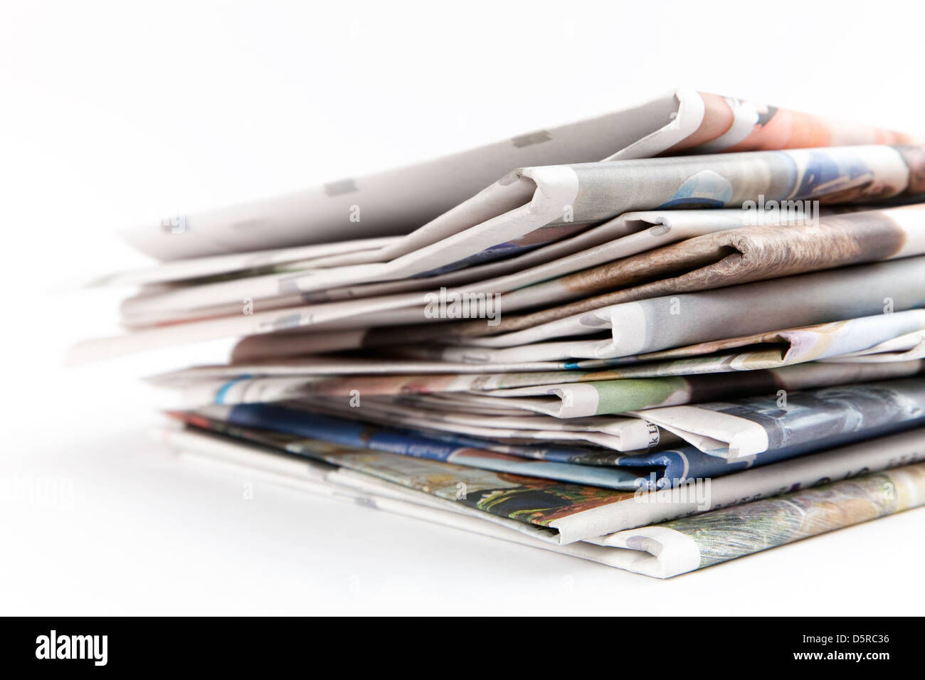 Stack of newspapers on white background Stock Photo - Alamy