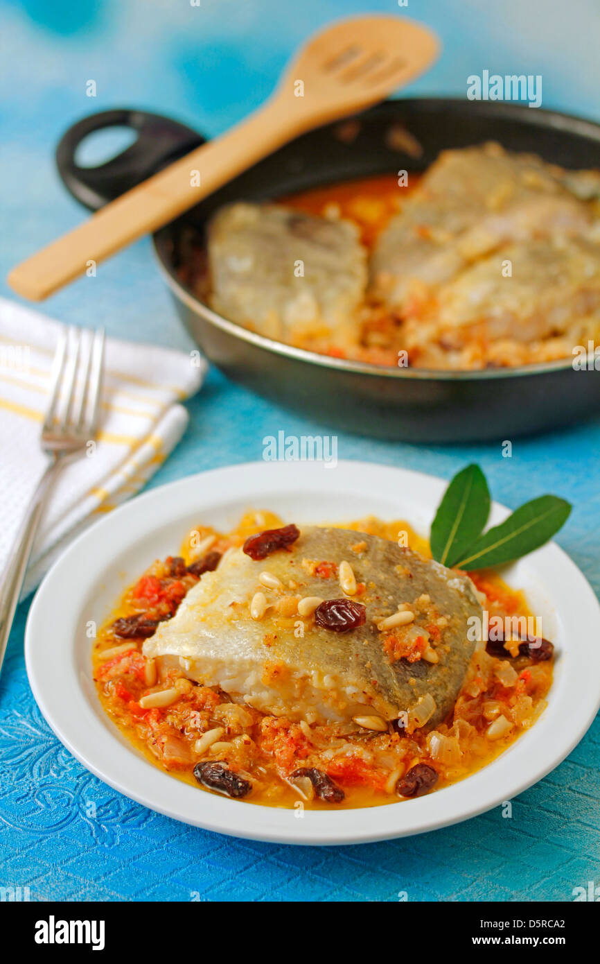 Cod with raisins and pine nuts. Recipe available Stock Photo - Alamy