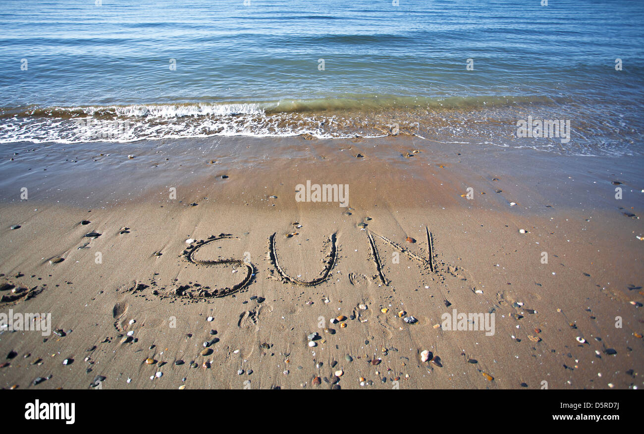 the word sun written in the wet sand at the beach Stock Photo - Alamy