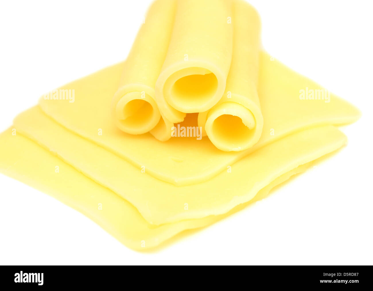 rolled and sliced cheese isolated on white Stock Photo - Alamy