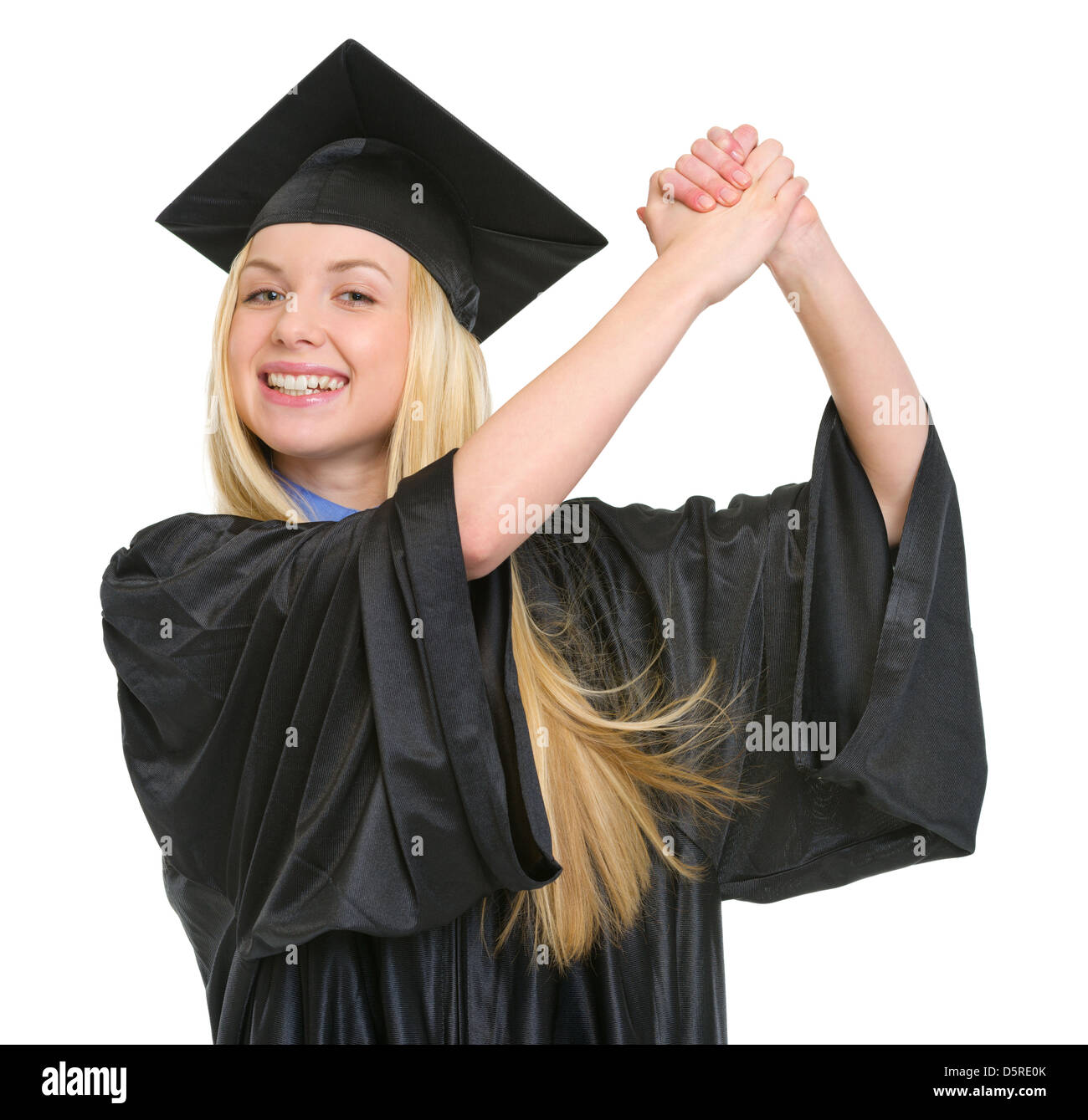 Smiling young woman in graduation gown rejoicing success Stock Photo ...