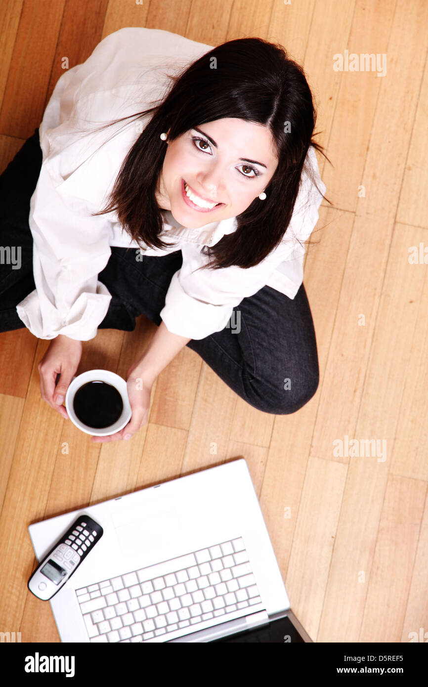 A young adult woman studying on the floor Stock Photo - Alamy