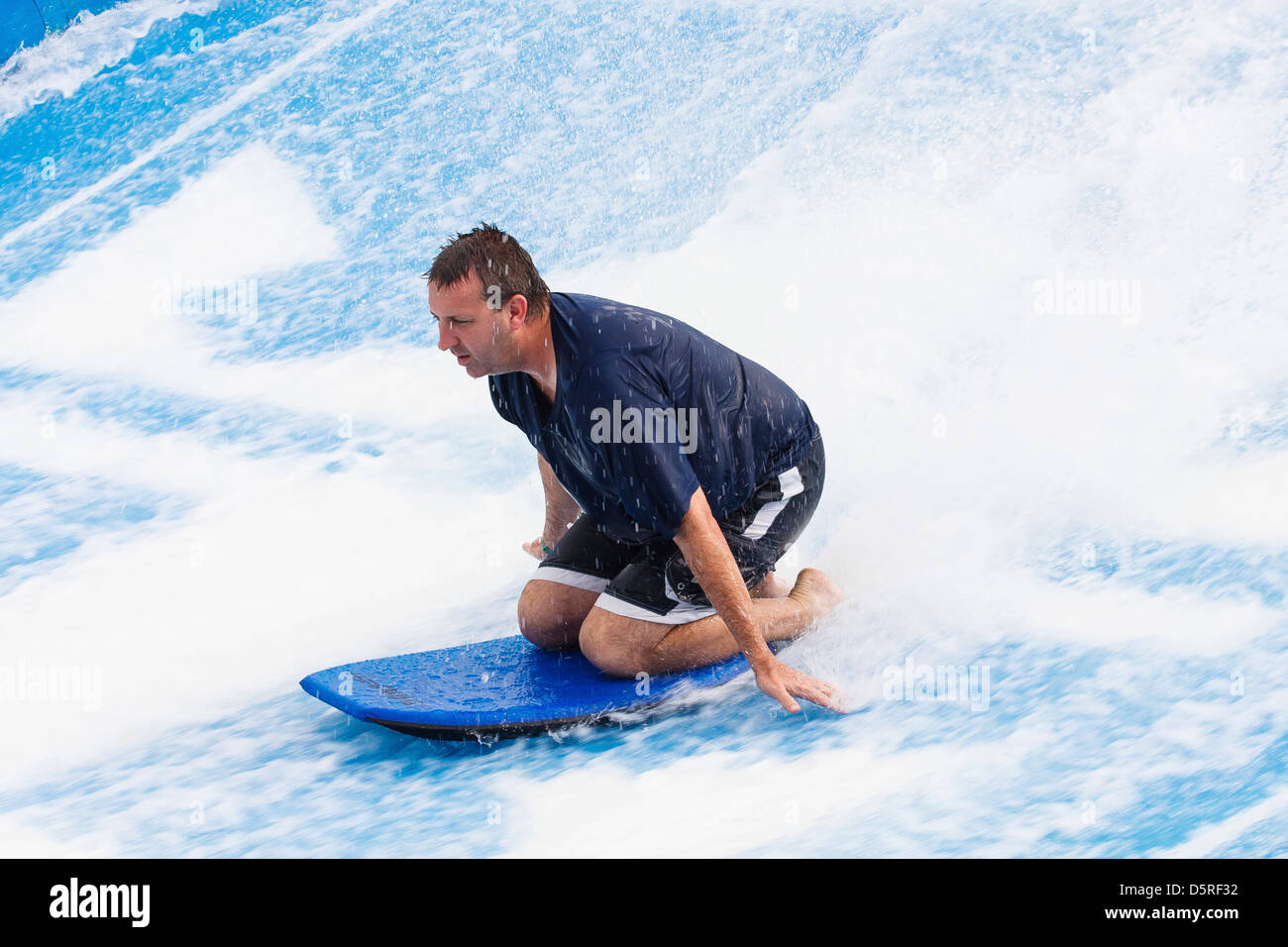 Man Surfing on a Flo-Rider on a Cruise Ship Stock Photo - Alamy