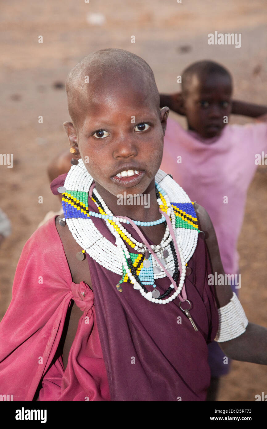 Africa, Tanzania;Young Maasai girl in traditional dress with hand made ...