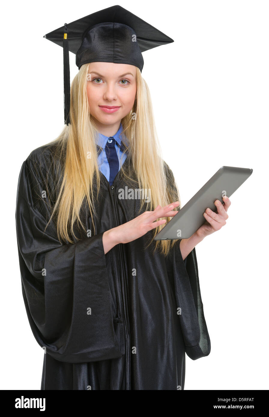 Young woman in graduation gown using tablet pc Stock Photo - Alamy