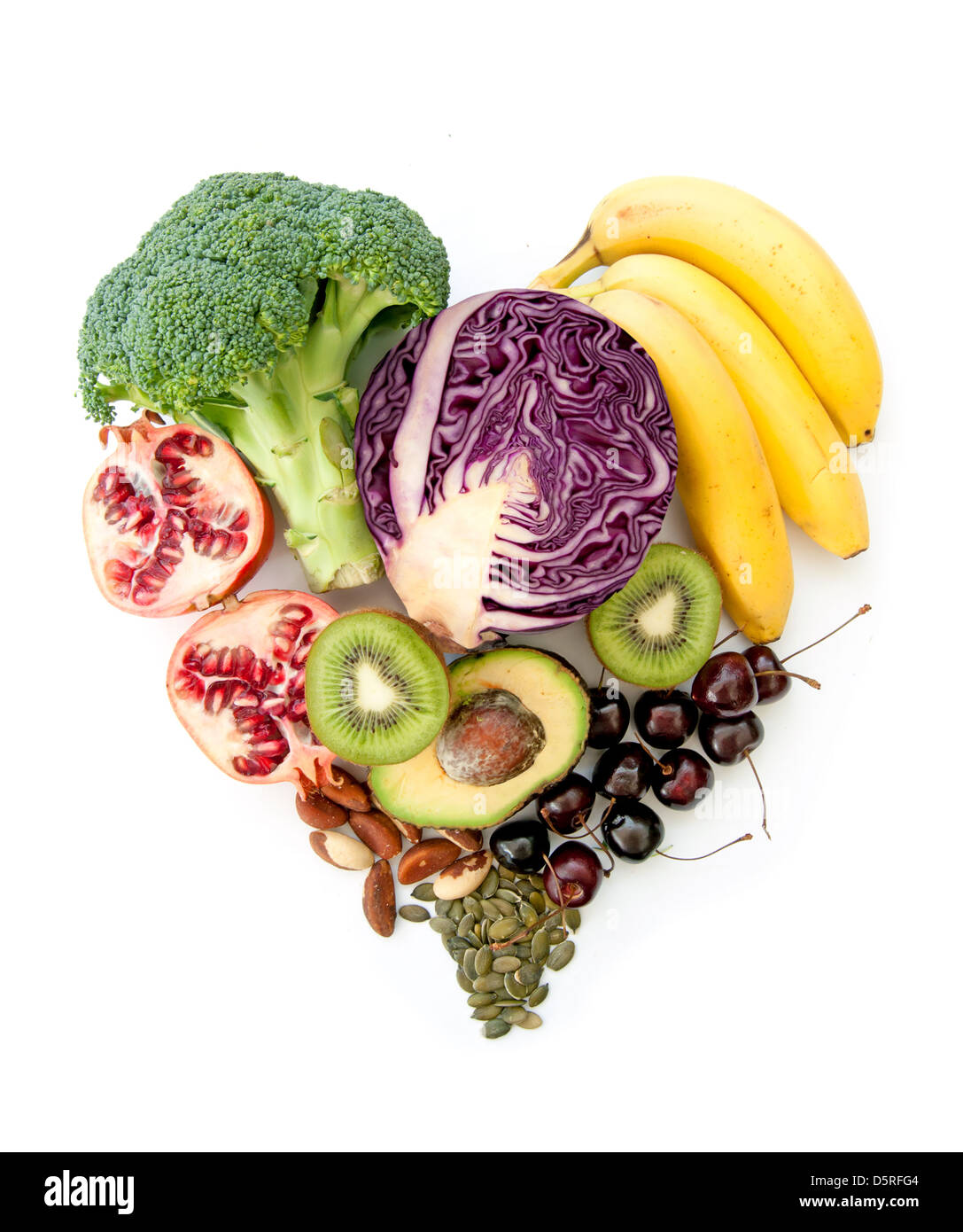 Super fruits and vegetables grouped together in a heartshape over a ...