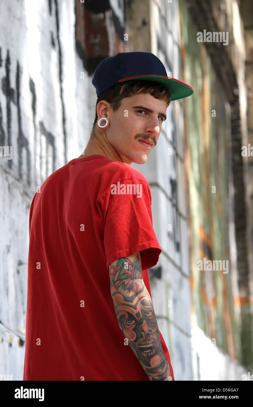 A young Rapper walking down a urban street Stock Photo - Alamy