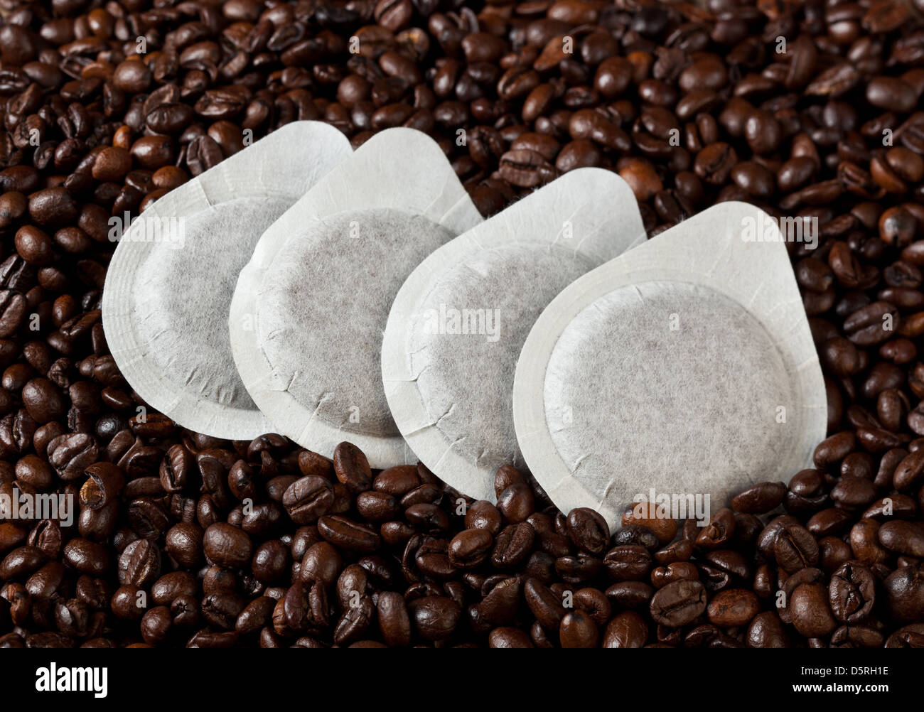 Coffee pods on coffee beans background Stock Photo - Alamy