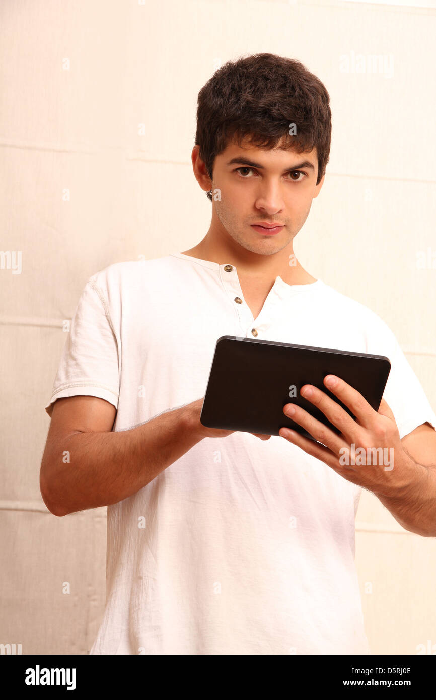 A young hispanic man using a Tablet PC Stock Photo - Alamy