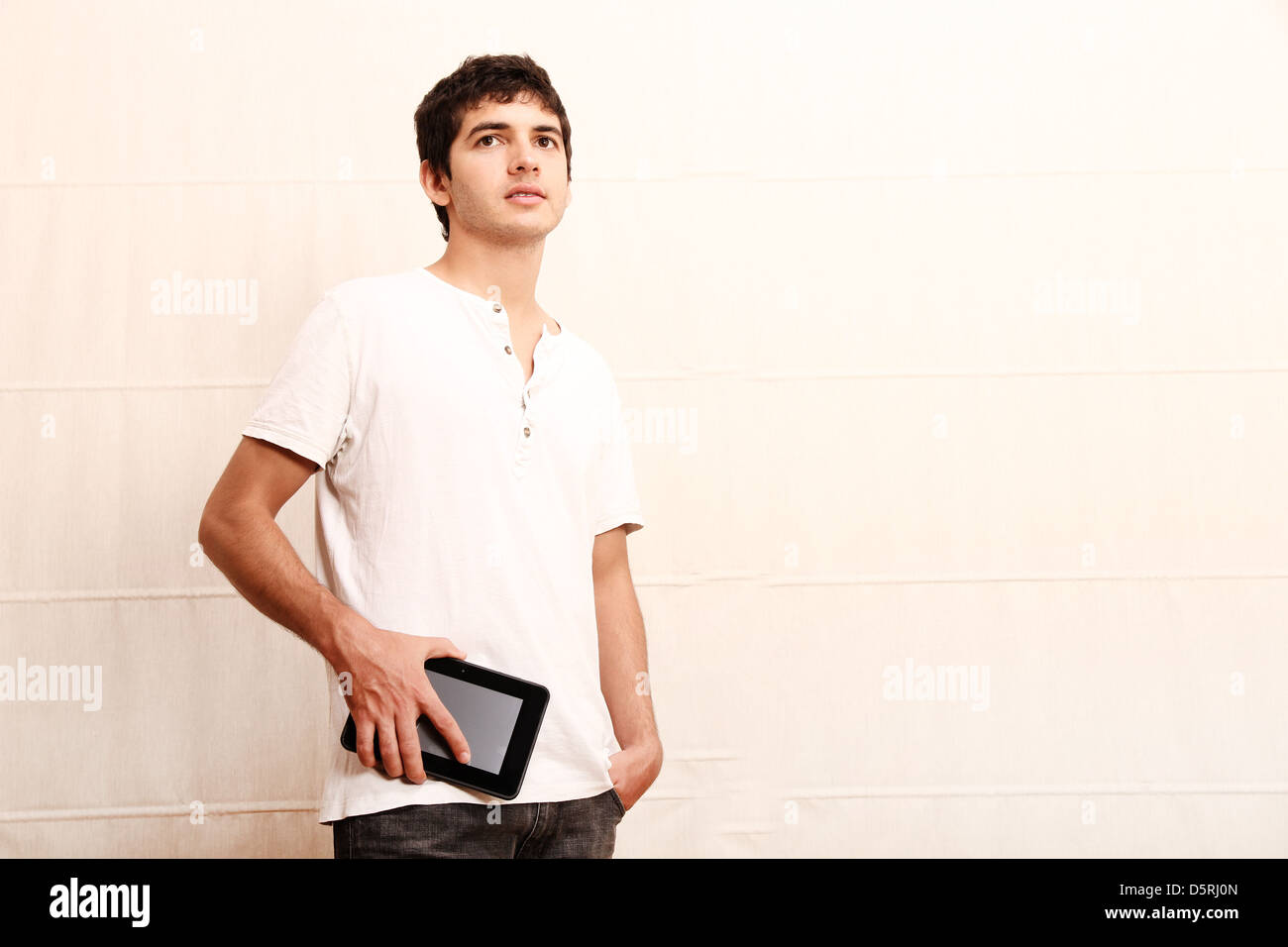 A young hispanic man using a Tablet PC Stock Photo - Alamy