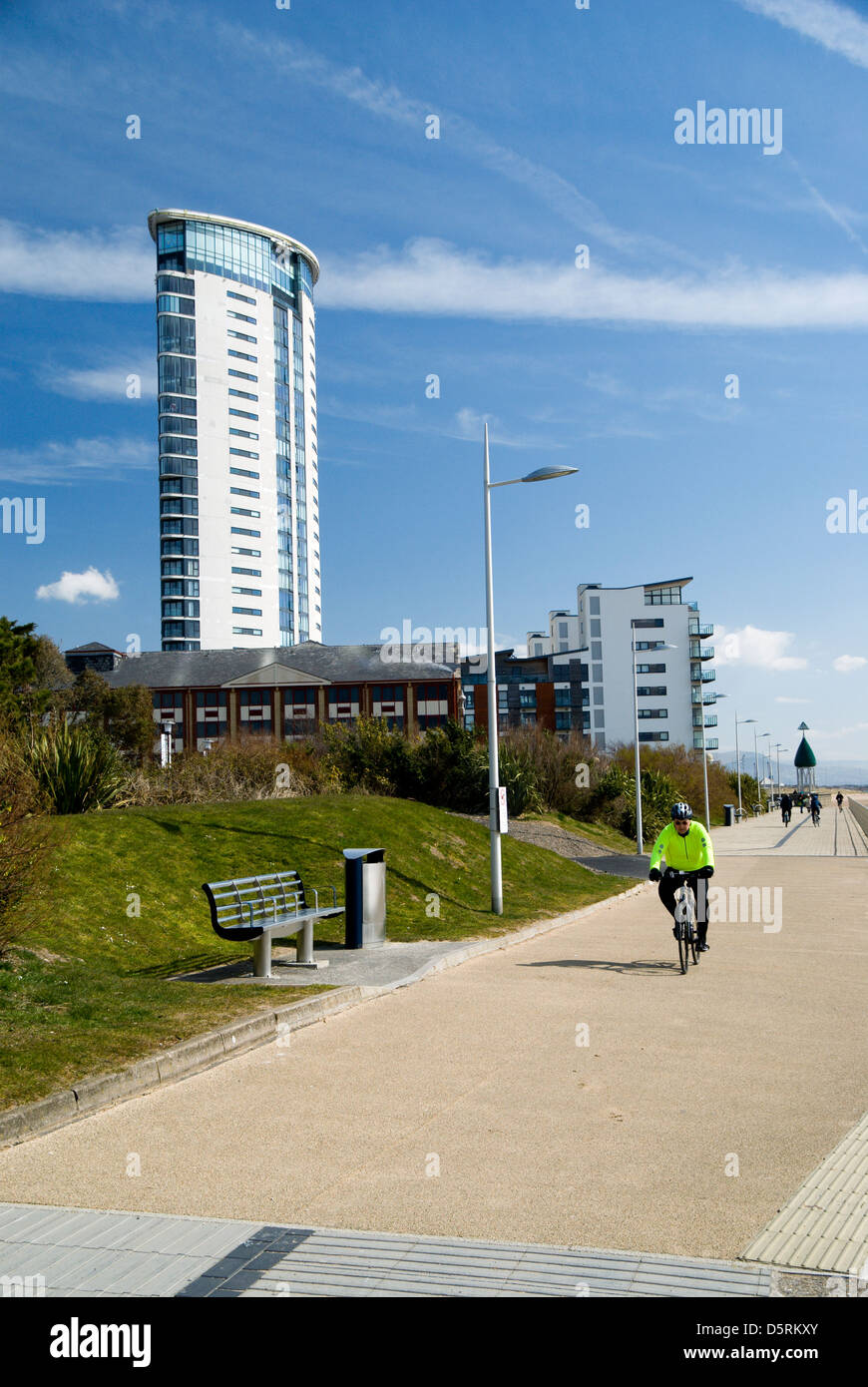 cyclist on swansea bay cycle path with The Tower in distance, swansea ...