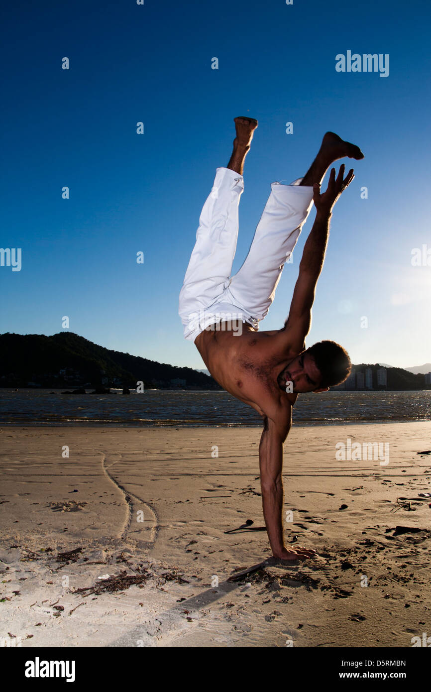 man doing "capoeira" martial arts at the beach Stock Photo - Alamy