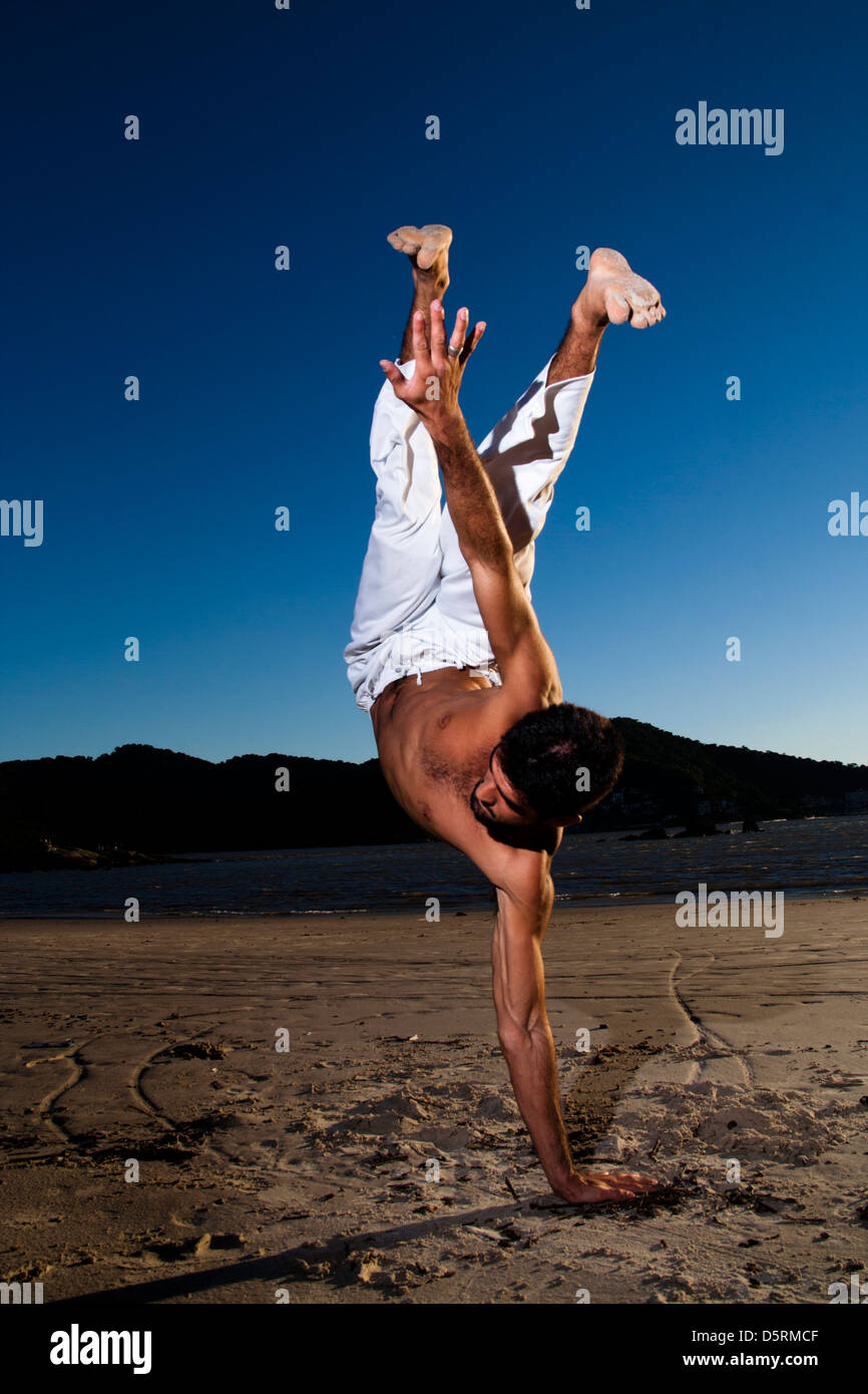 man doing "capoeira" martial arts at the beach Stock Photo - Alamy