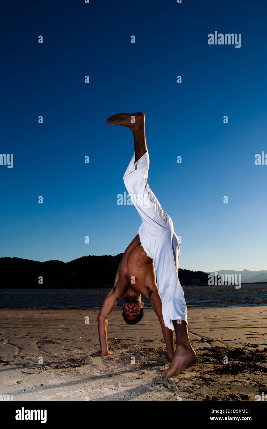 man doing "capoeira" martial arts at the beach Stock Photo - Alamy