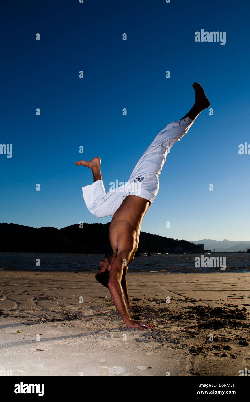 man doing "capoeira" martial arts at the beach Stock Photo - Alamy