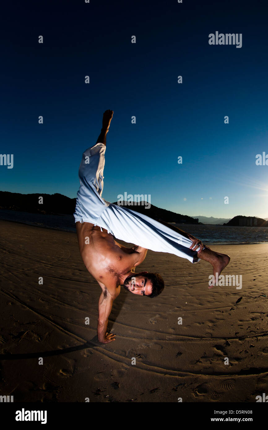 man doing "capoeira" martial arts at the beach Stock Photo - Alamy