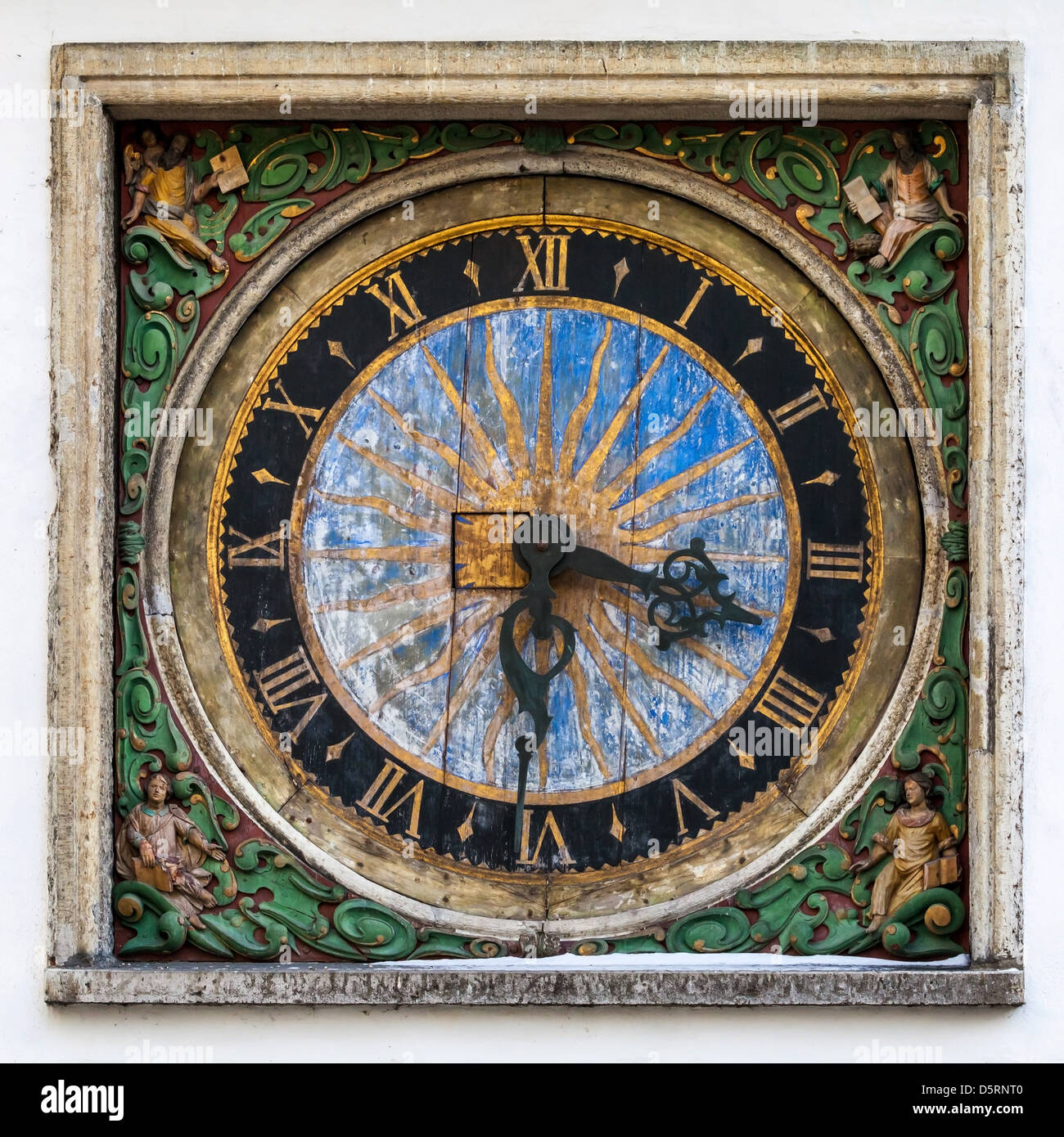 Ancient outdoor clock on white wall in old Tallinn, Estonia Stock Photo ...