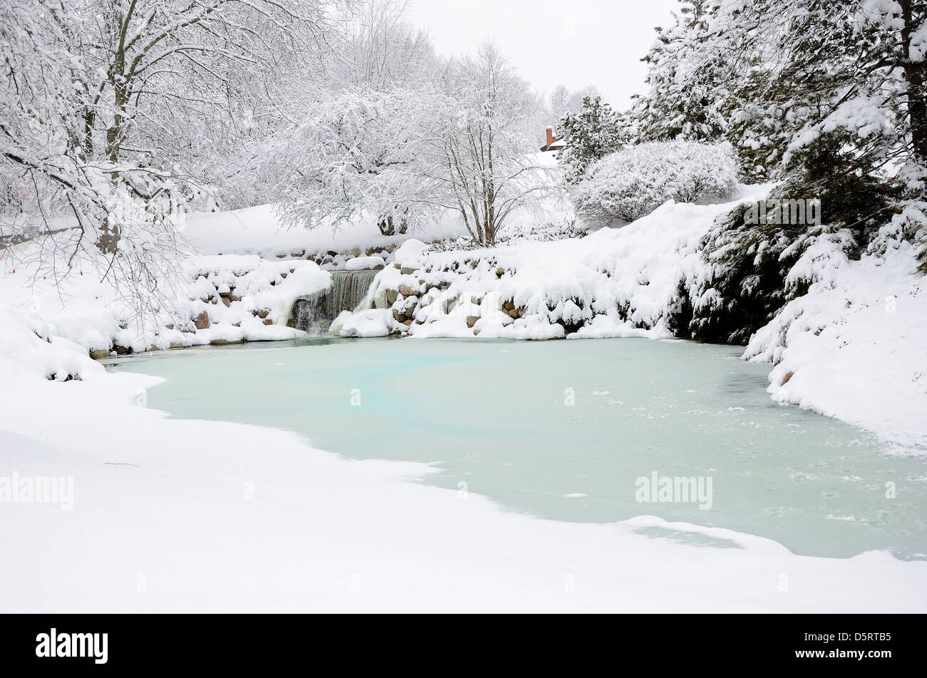Snow covered waterfall and pond Stock Photo - Alamy
