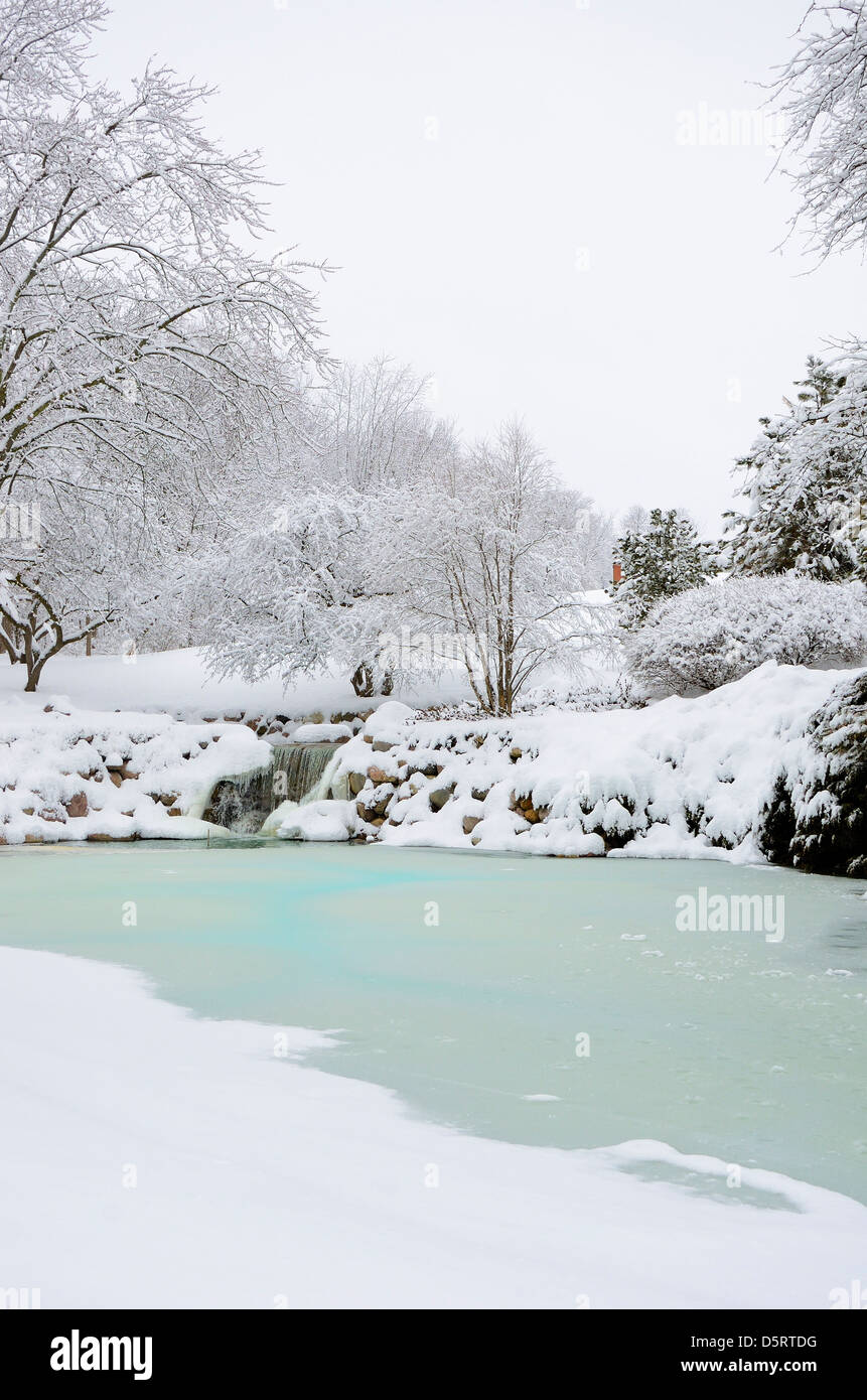 Snow covered waterfall and pond Stock Photo - Alamy